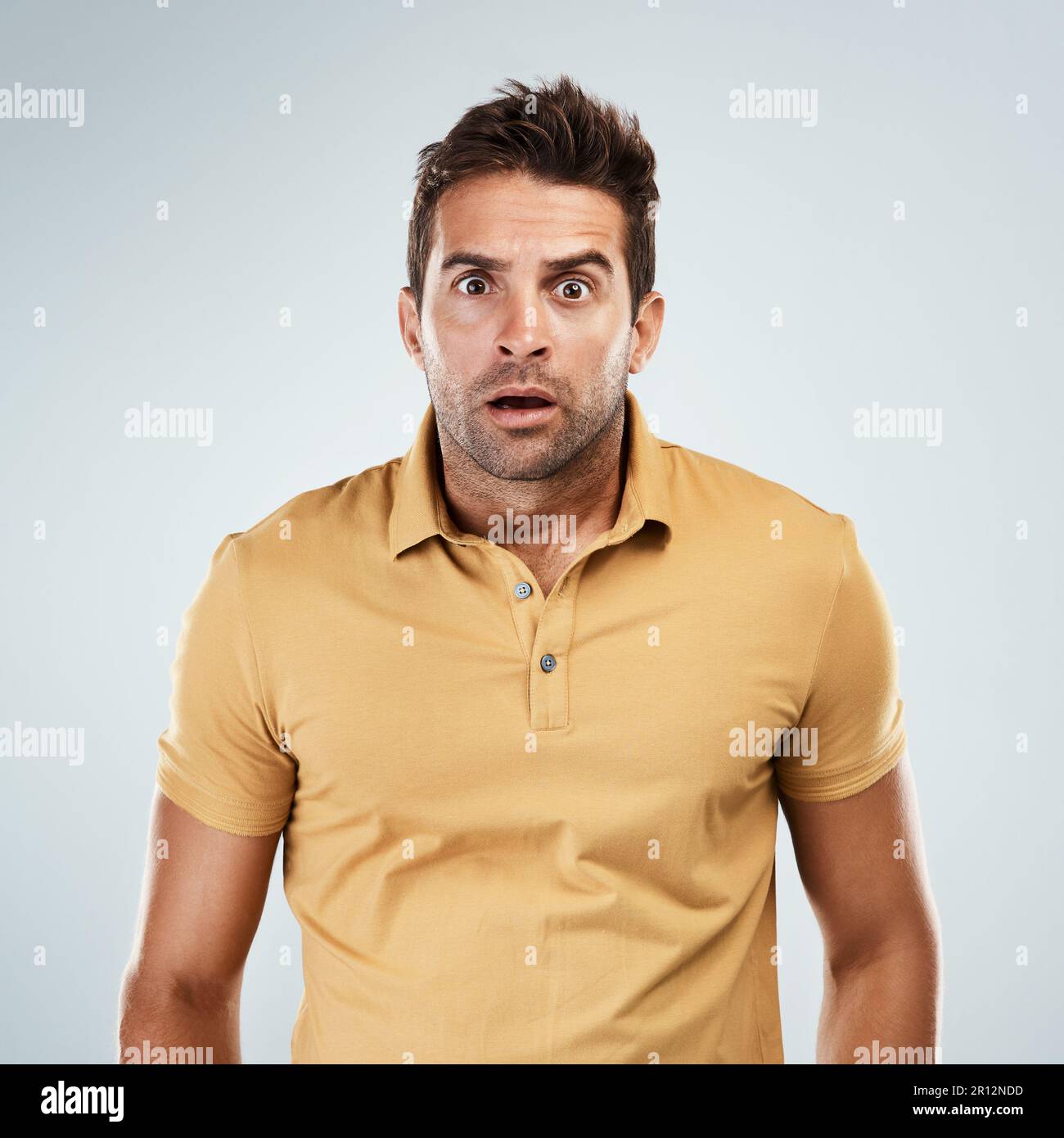 Am I hearing you correctly. Portrait of a young man with a scared ...