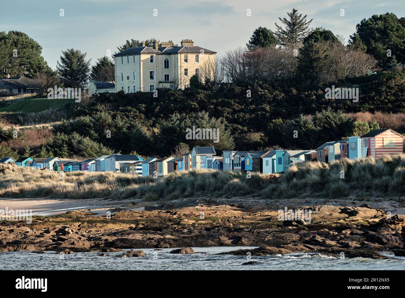 A picturesque beach village with traditional beach huts providing a ...