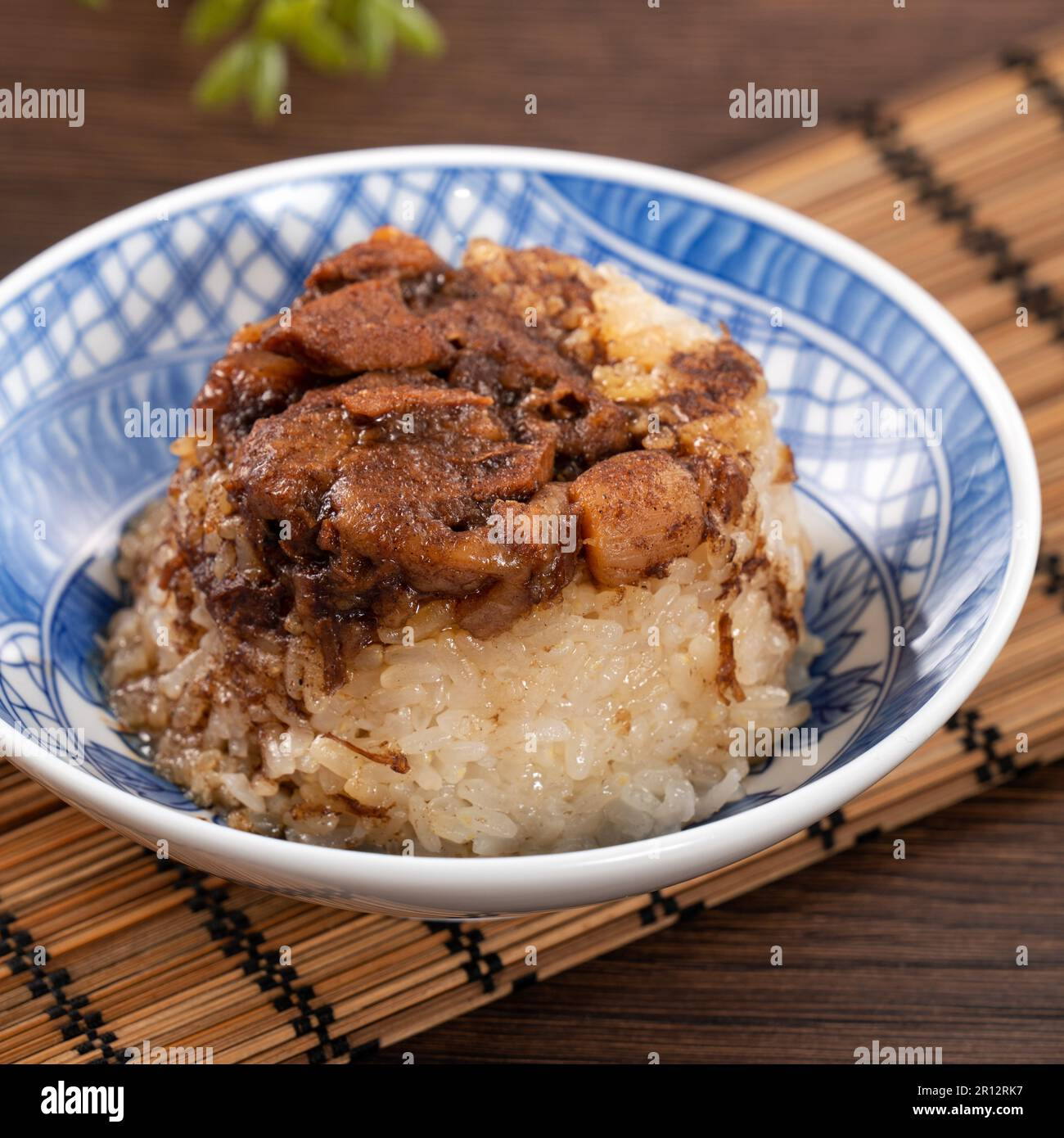 Migao, tube rice cake, rice pudding in a bowl topped with minced pork ...