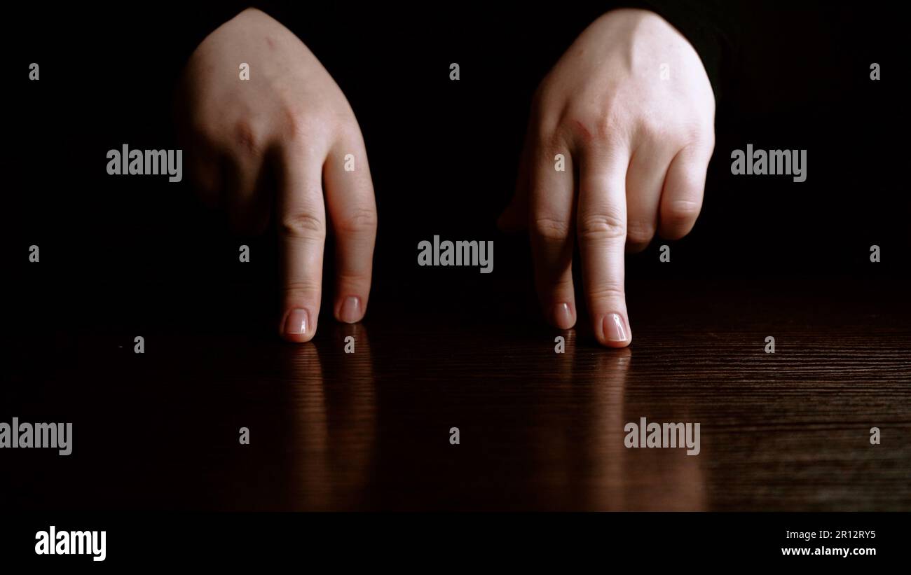 Male fingers dancing on a dark background. Fun and theater concept ...