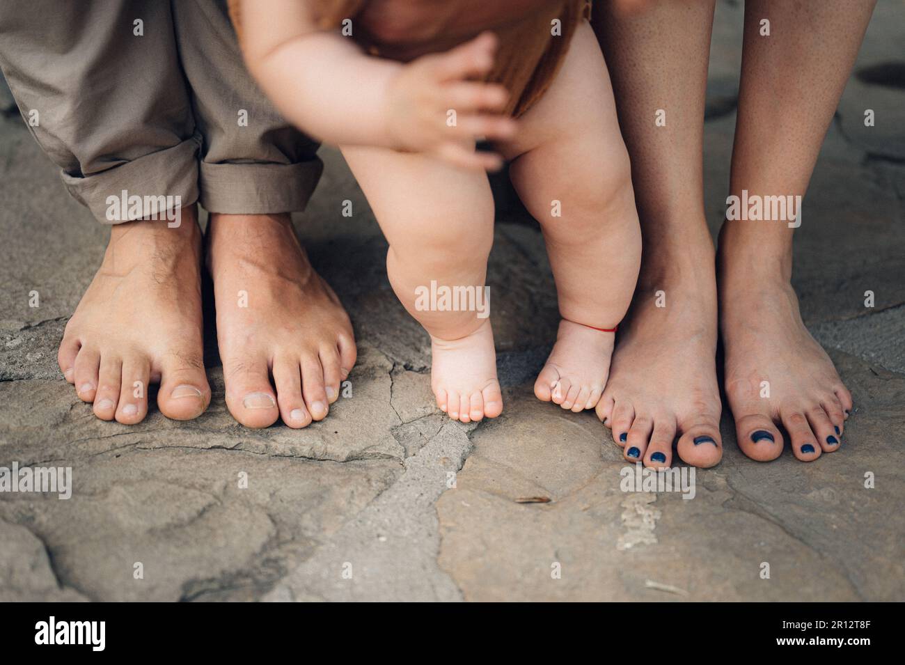 A closeup shot of the feet of family members Stock Photo - Alamy