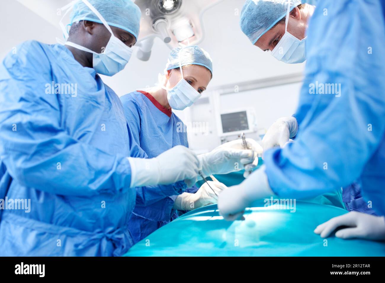 Medical Professionals. Surgical doctors wearing scrubs performing ...