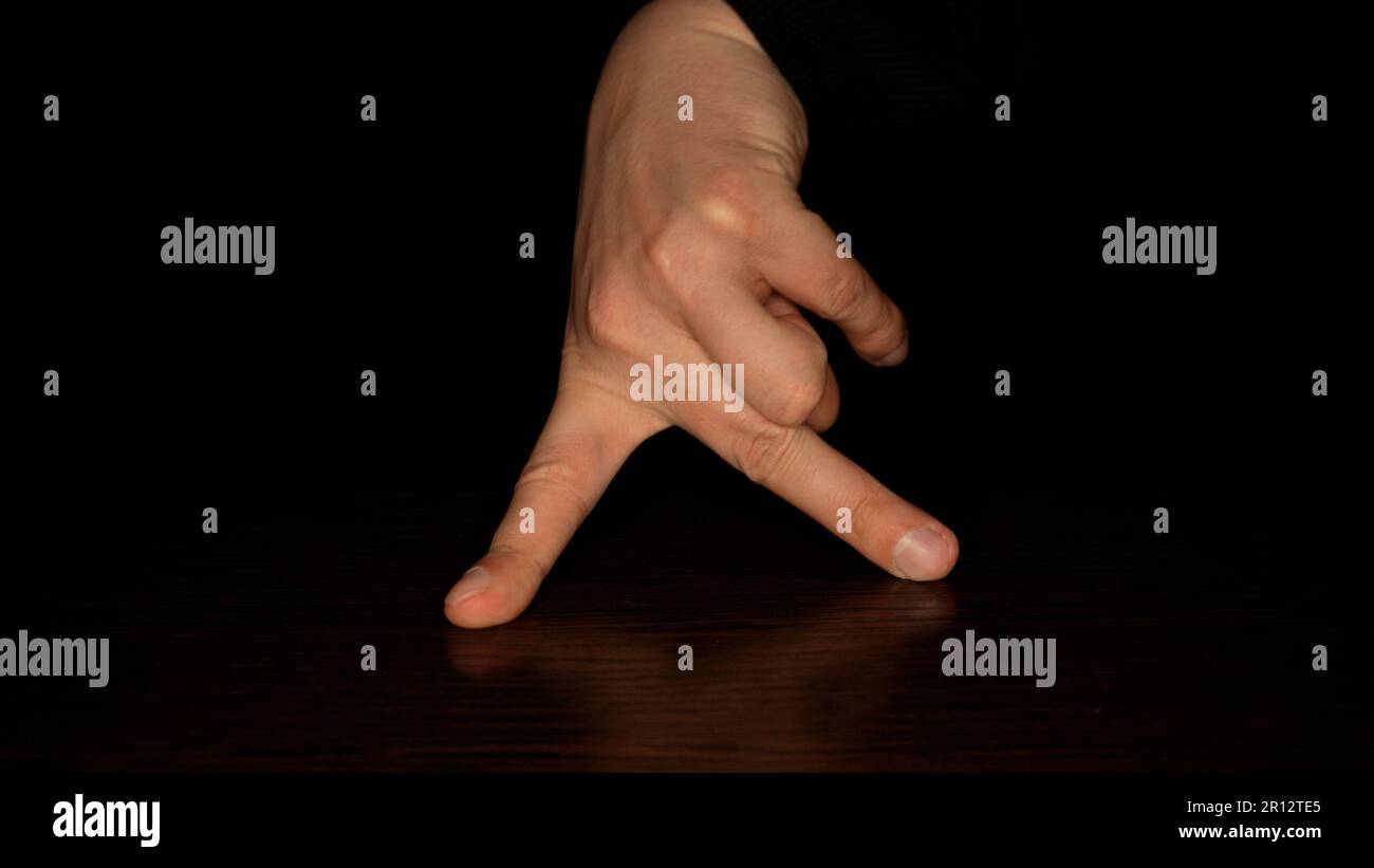 Male fingers dancing on a dark background. Fun and theater concept ...