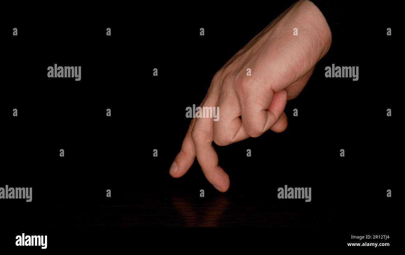 Male fingers dancing on a dark background. Fun and theater concept ...