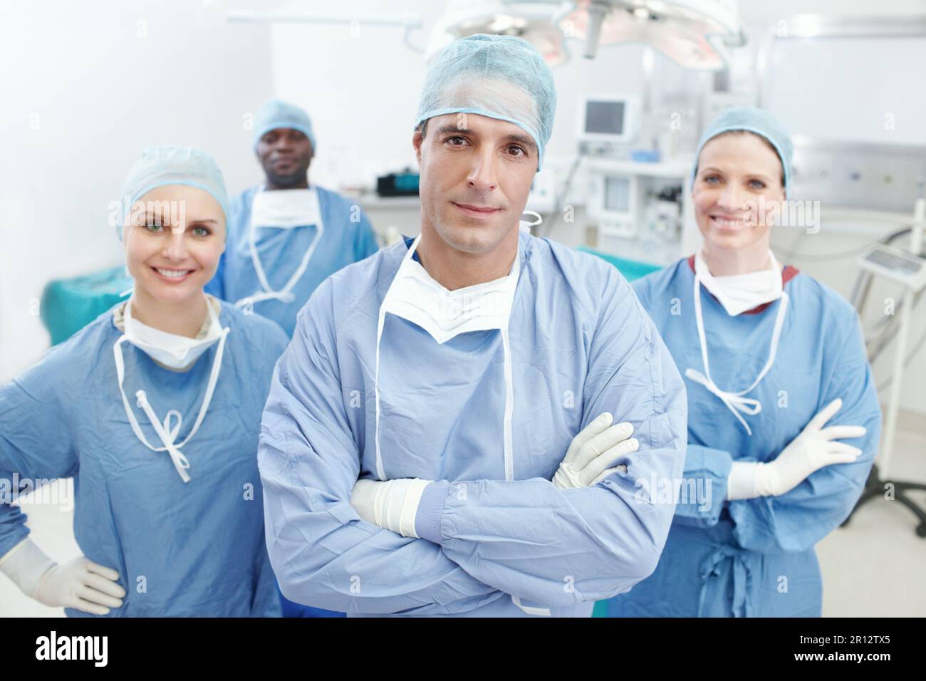Skilled surgical team. Portrait of two female nurses and a male doctor ...