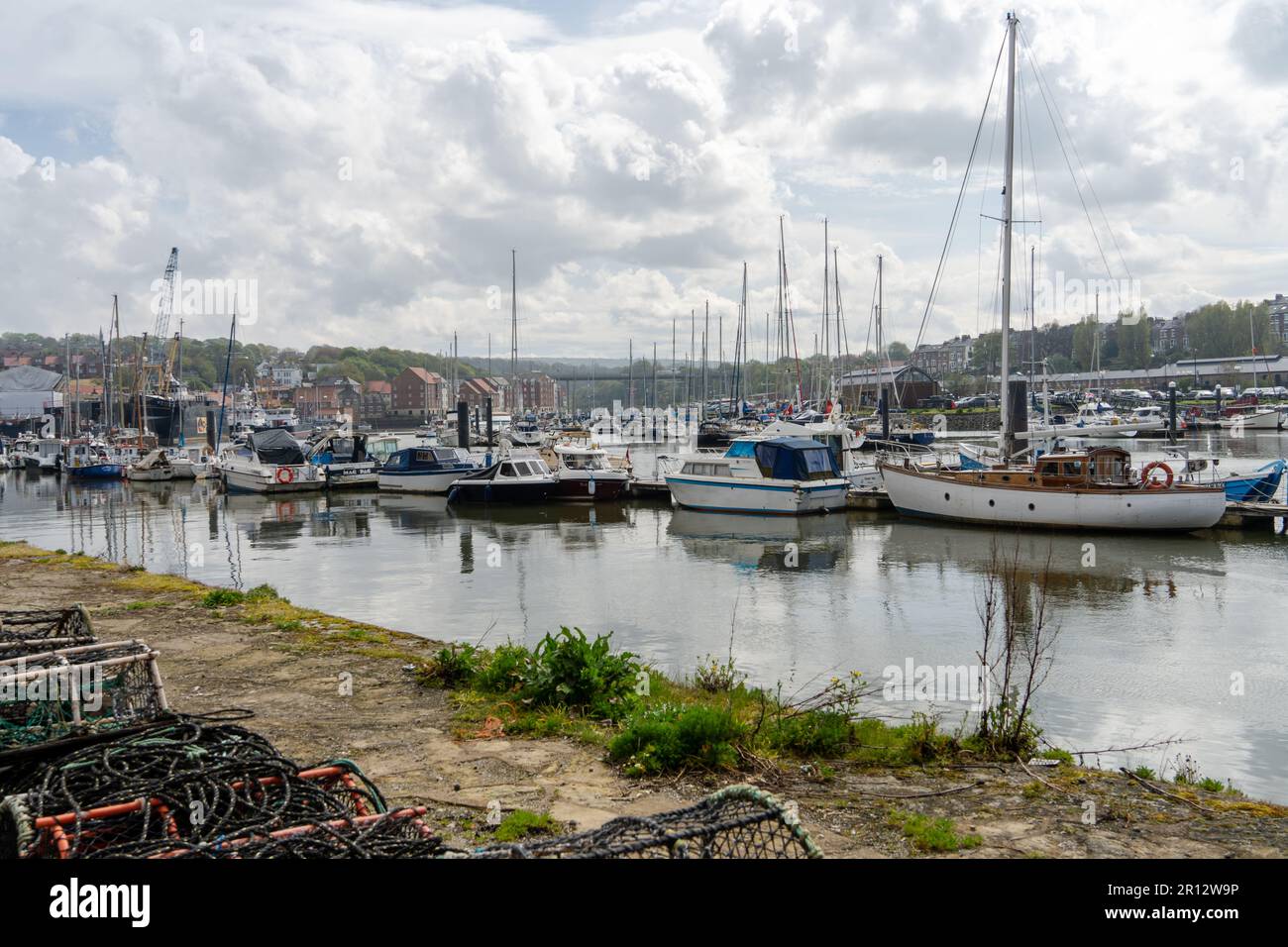 Boats in the harbour of the pretty coastal town of Whitby, UK, popular ...