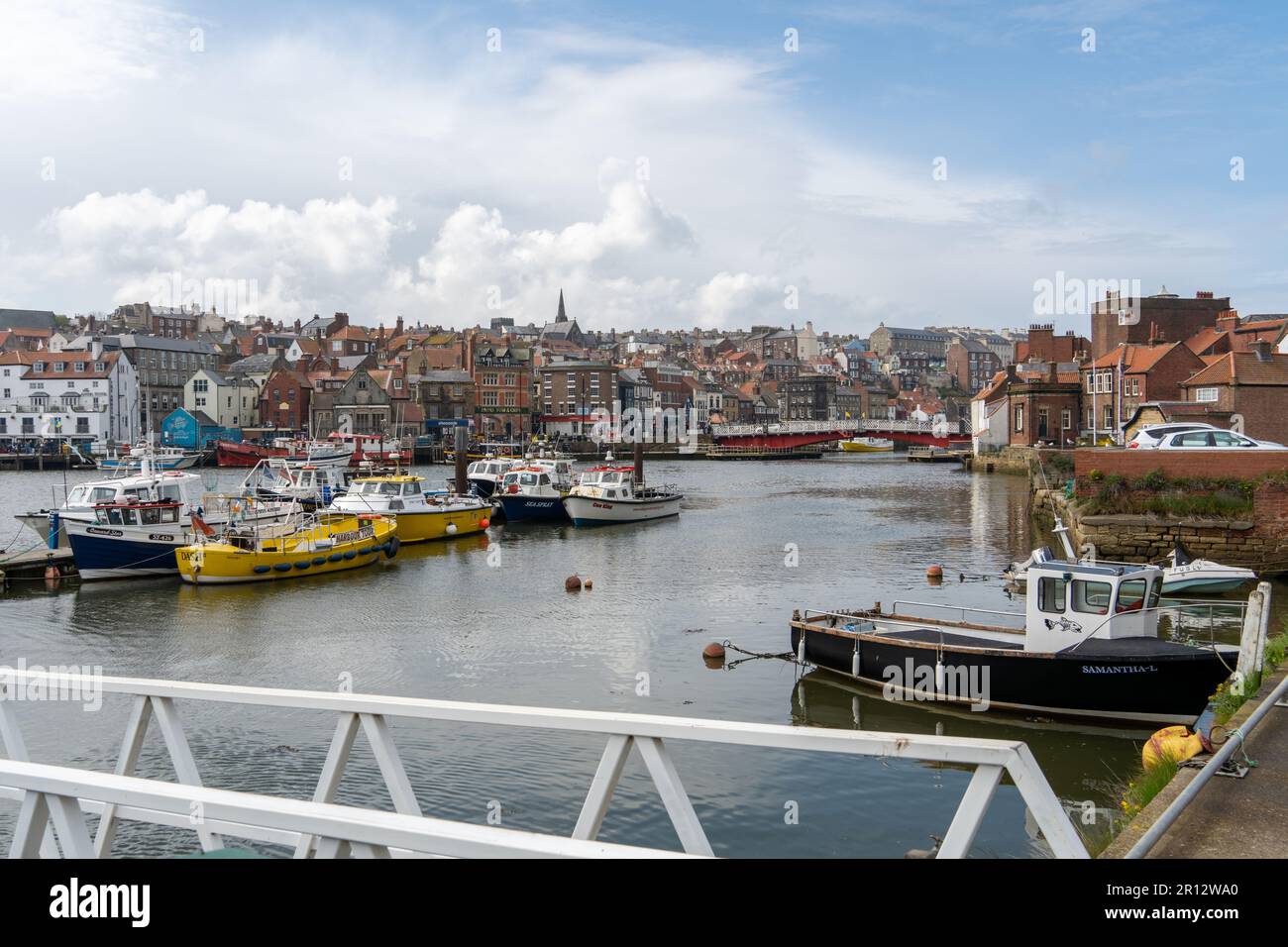 Boats in the harbour of the pretty coastal town of Whitby, UK, popular ...