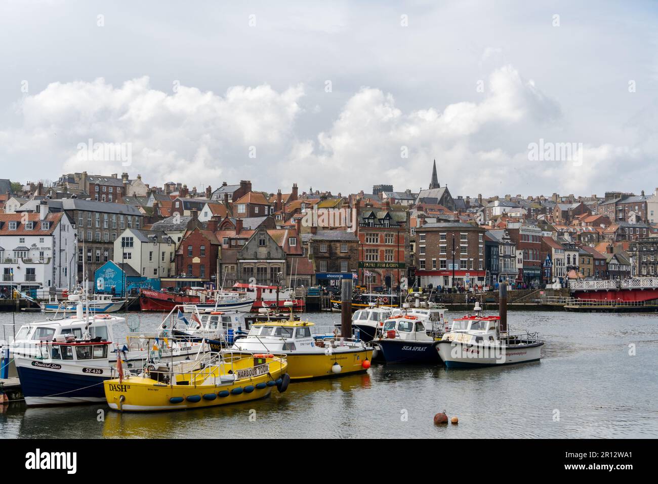 Boats in the harbour of the pretty coastal town of Whitby, UK, popular ...
