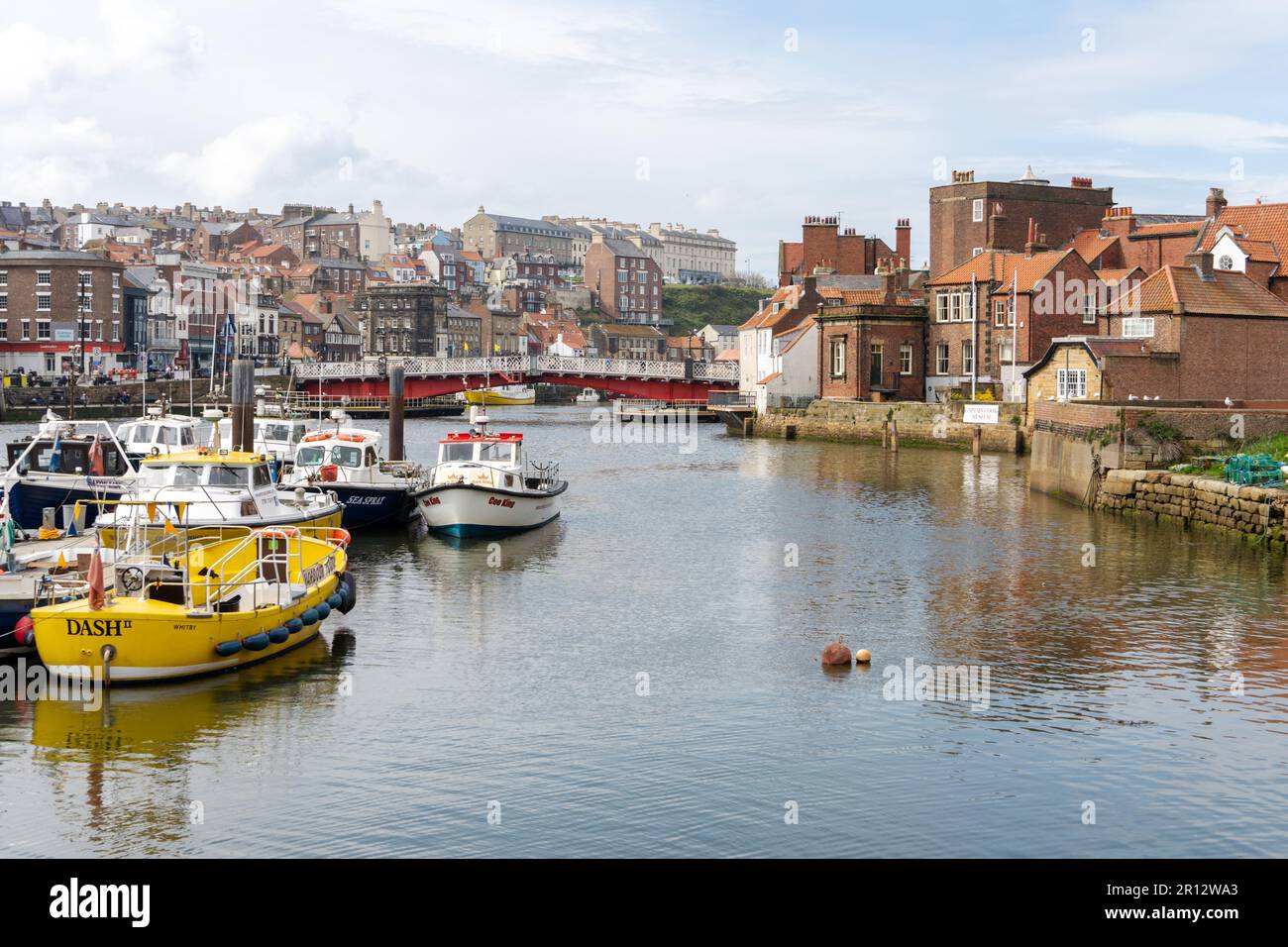 Boats in the harbour of the pretty coastal town of Whitby, UK, popular ...