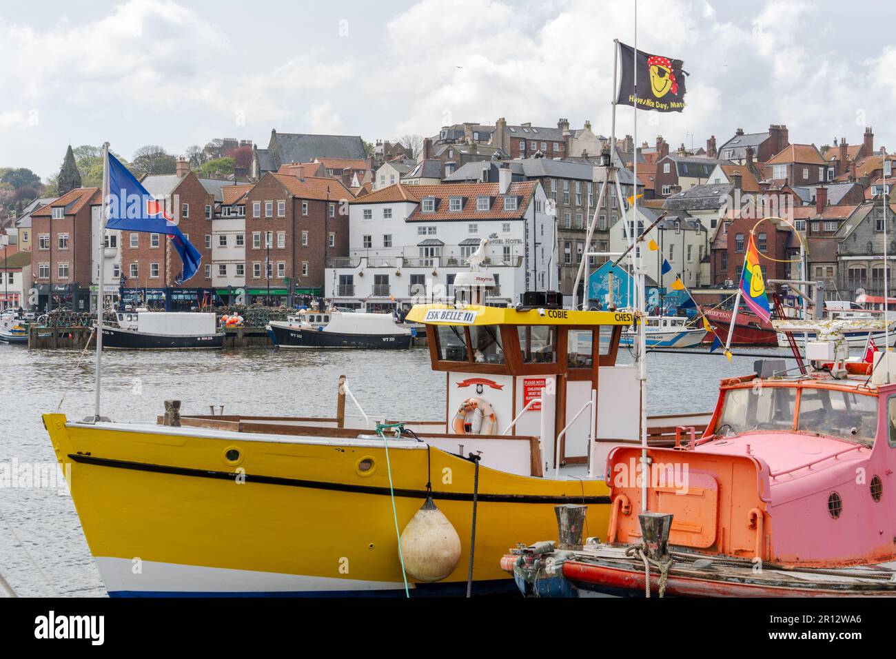 Boats in the harbour of the pretty coastal town of Whitby, UK, popular ...