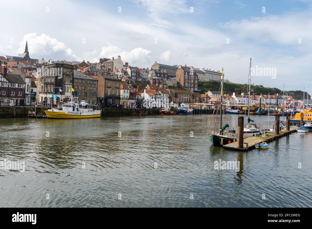 Boats in the harbour of the pretty coastal town of Whitby, UK, popular ...