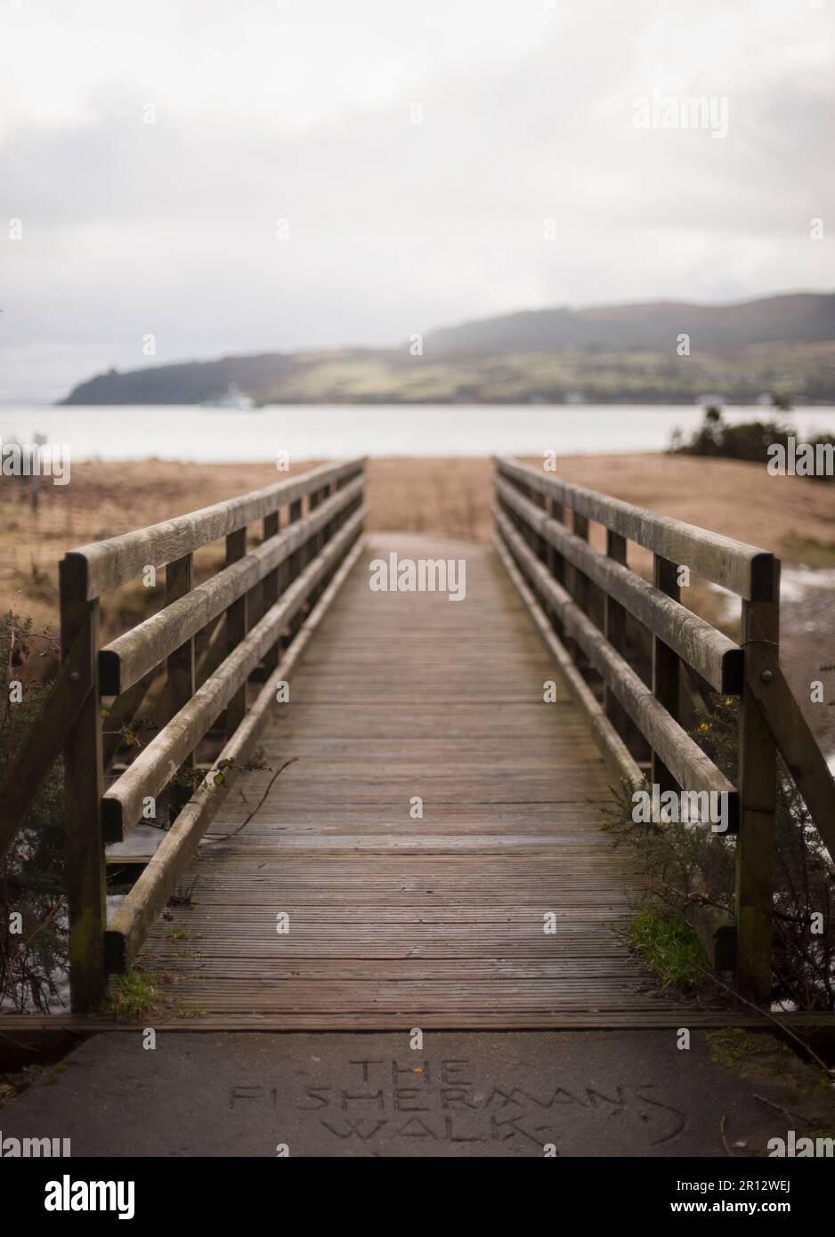 A wooden bridge crosses a stream on the Fishermans walk within a ...