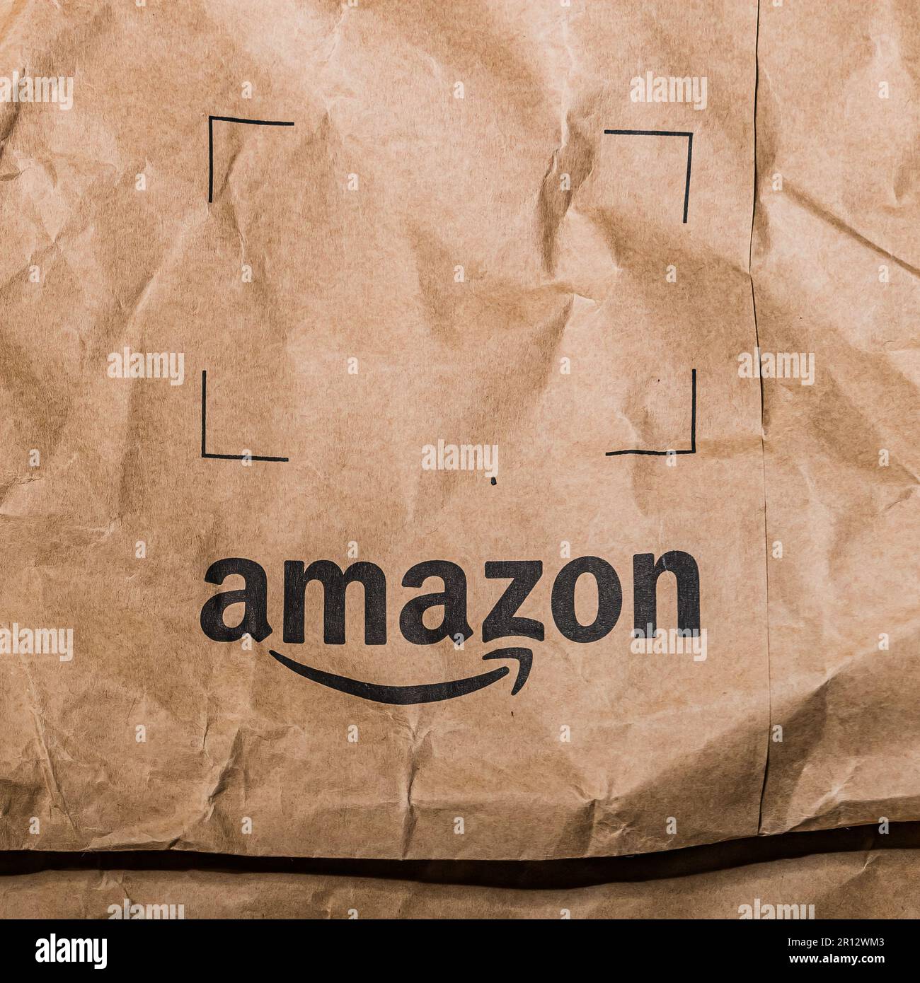 A brown paper shopping bag featuring the Amazon logo on the front Stock ...