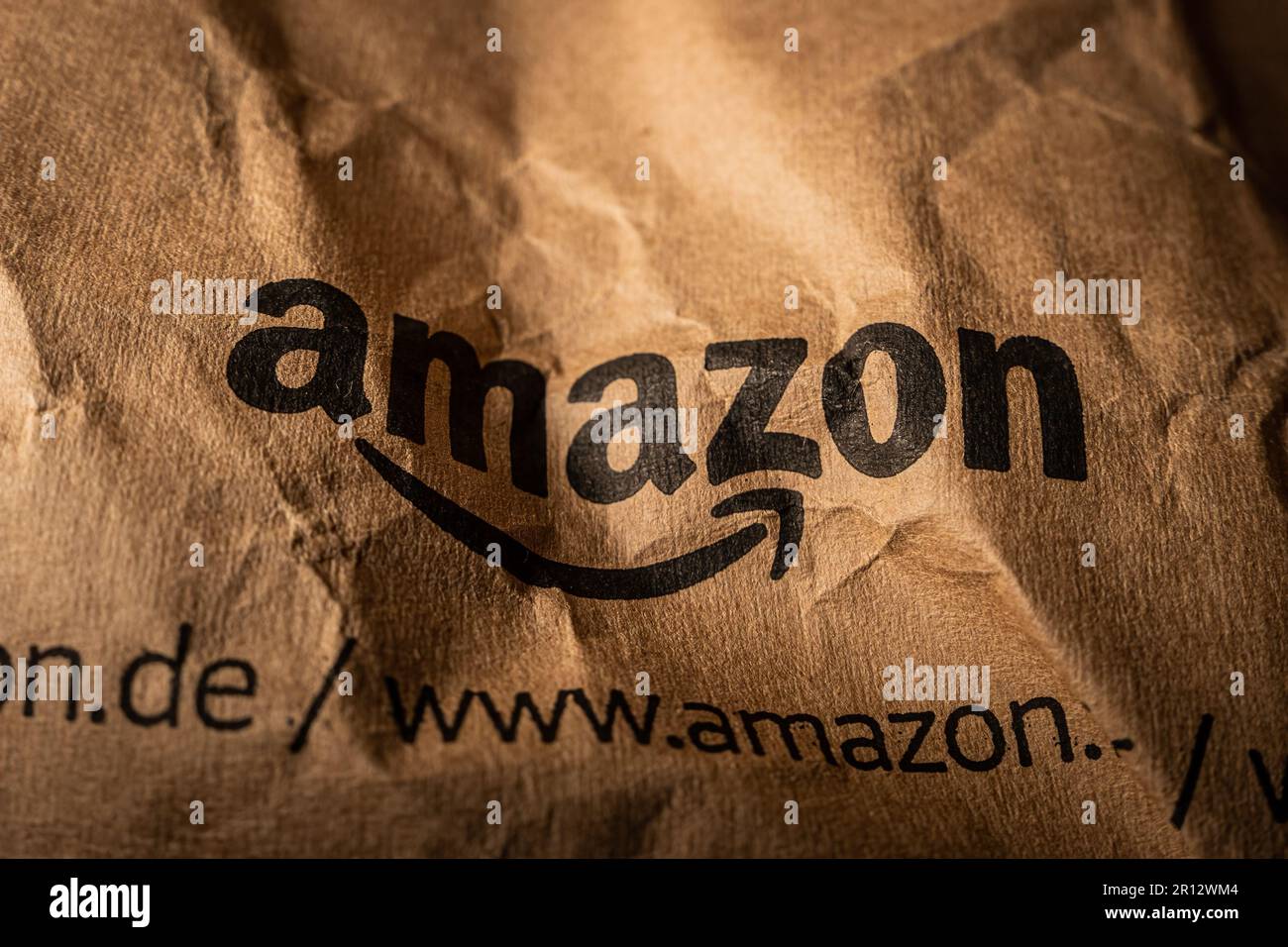 A brown paper shopping bag featuring the Amazon logo on the front Stock ...