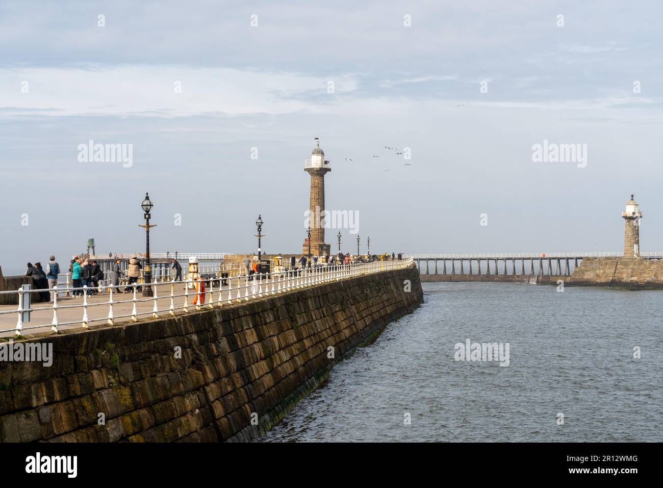 Whitby Pier, popular with tourists visiting the town of Whitby, North ...