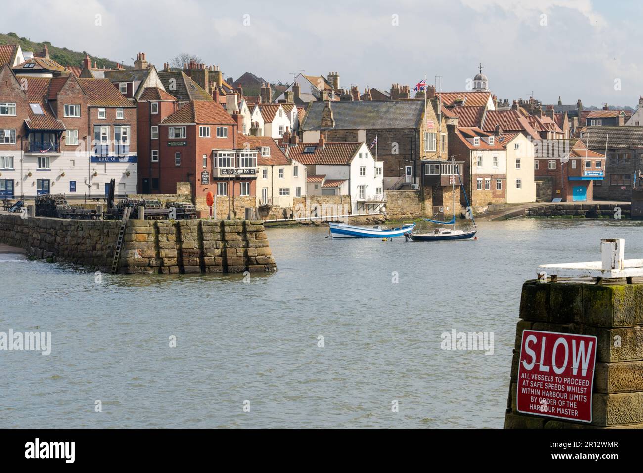Boats in the harbour of the pretty coastal town of Whitby, UK, popular ...