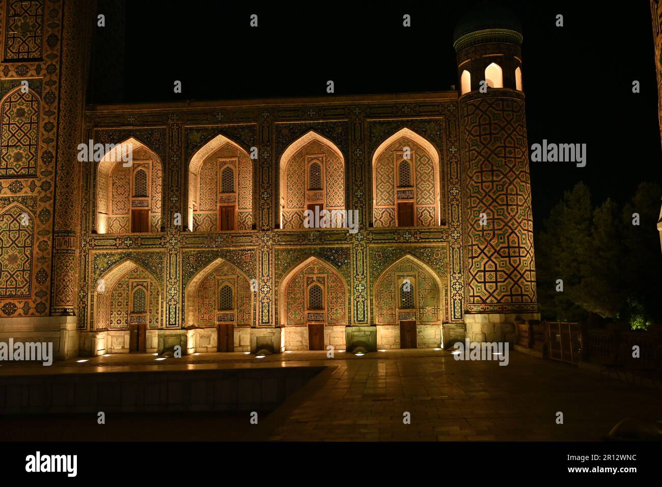 Night view of Registan square and its madrasahs with colorful lights in ...