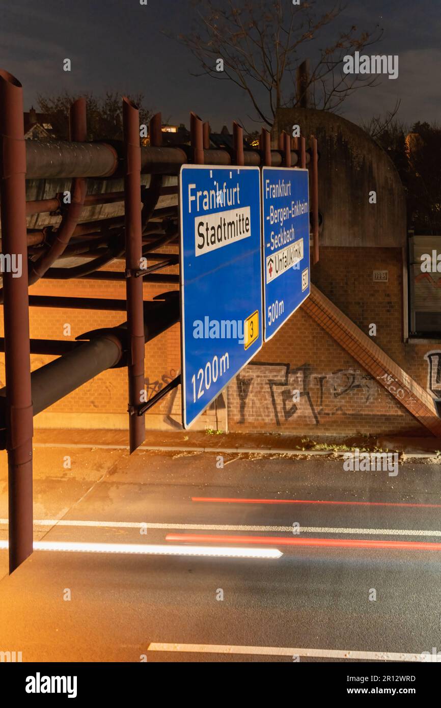 The blue signs with directions above the road at night. Frankfurt ...