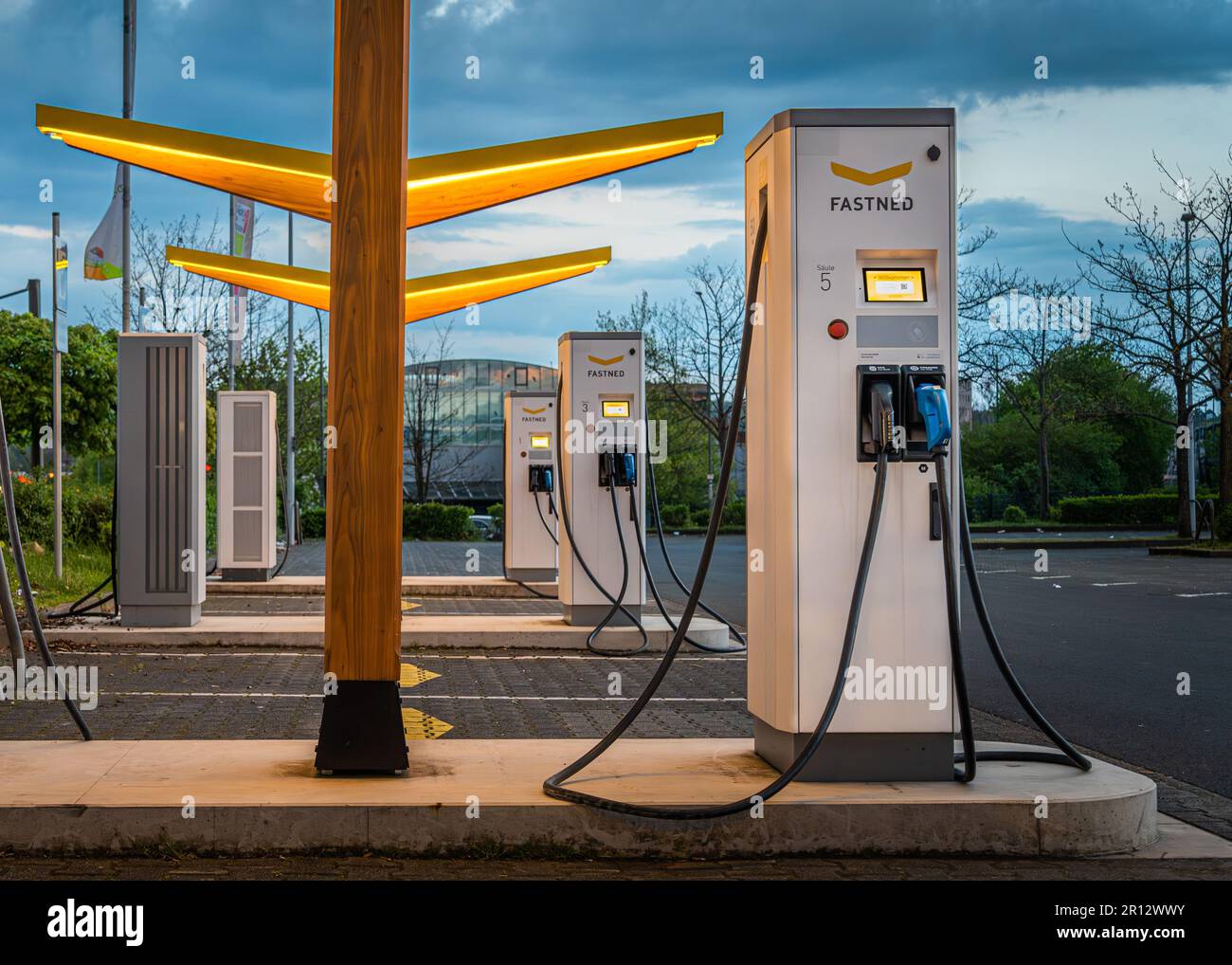 The electric car charging ports illuminated by bright yellow lights in ...