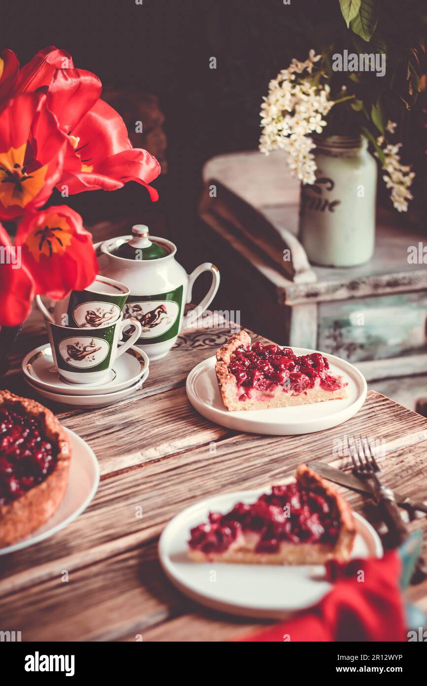 A piece of cherry pie for morning tea. Moody photo Stock Photo - Alamy
