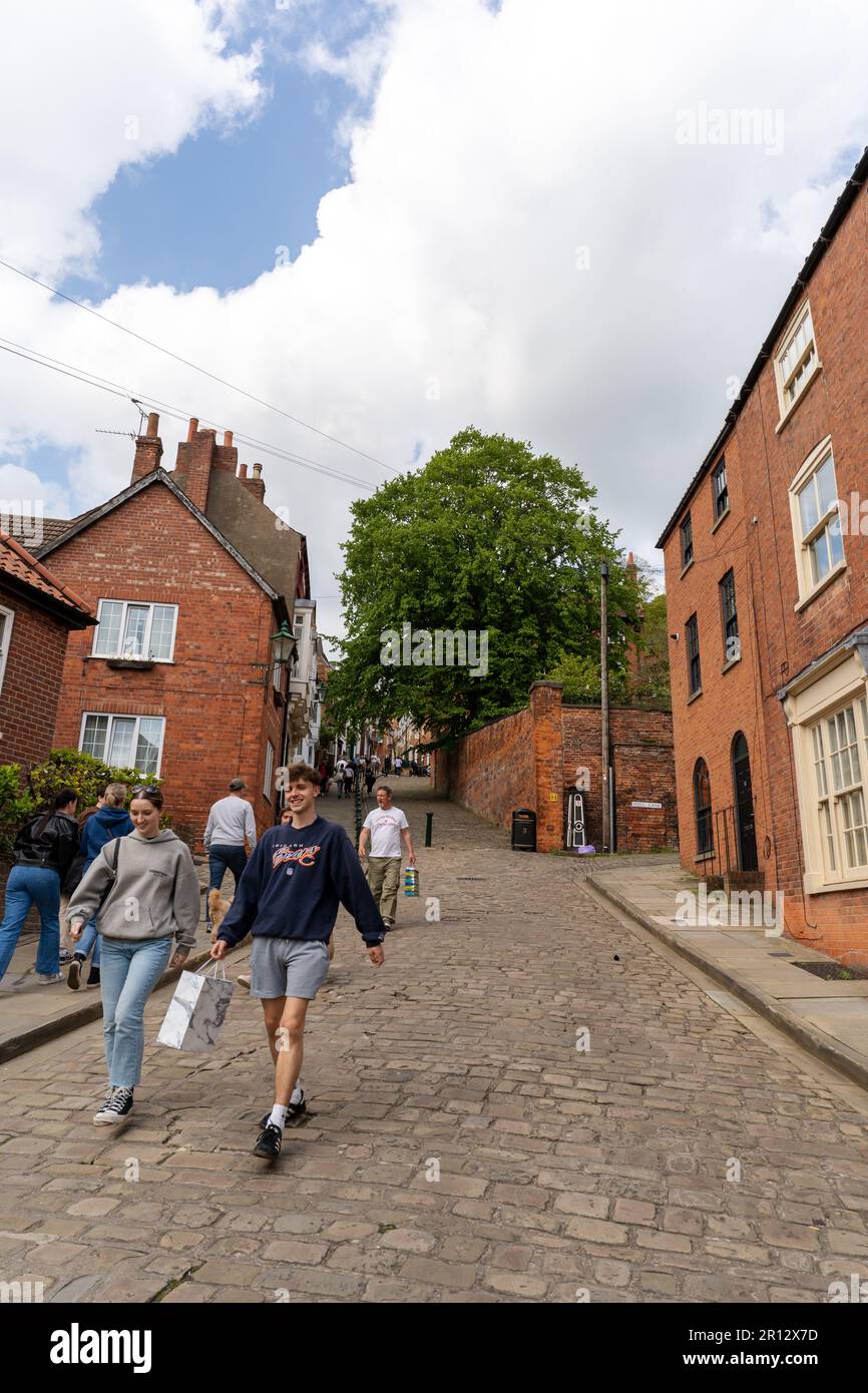 People walking Steep Hill, Lincoln, UK, a popular tourist attraction in ...