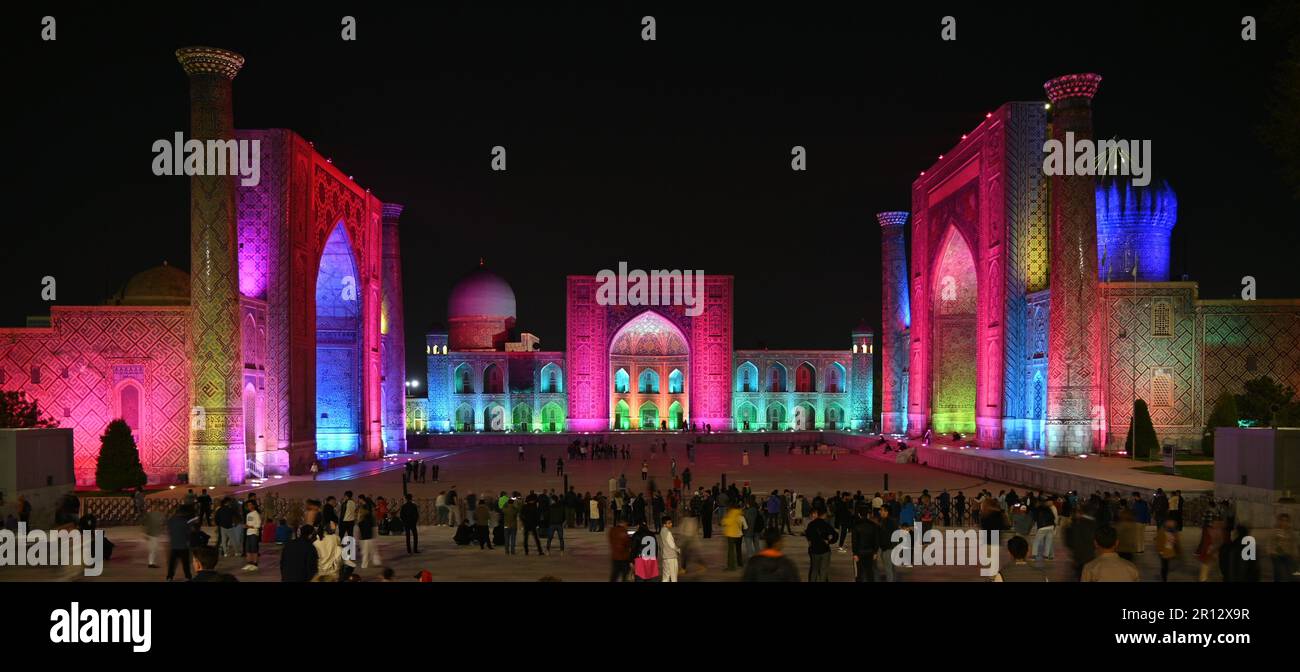 Night view of Registan square and its madrasahs with colorful lights in ...