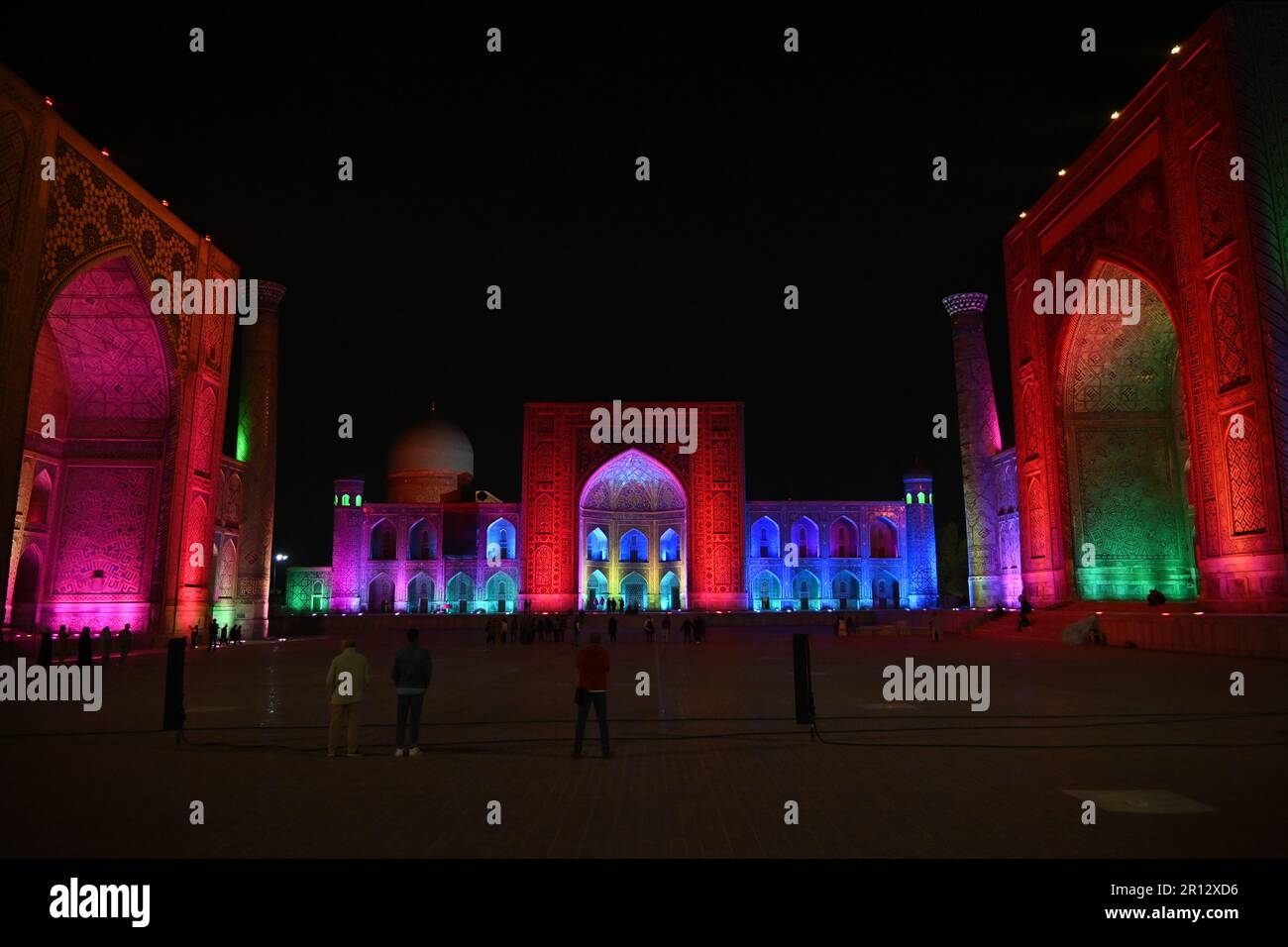 Night view of Registan square and its madrasahs with colorful lights in ...