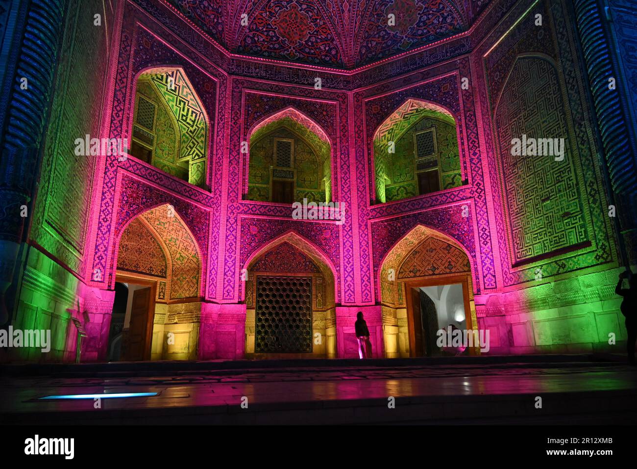 Night view of Registan square and its madrasahs with colorful lights in ...