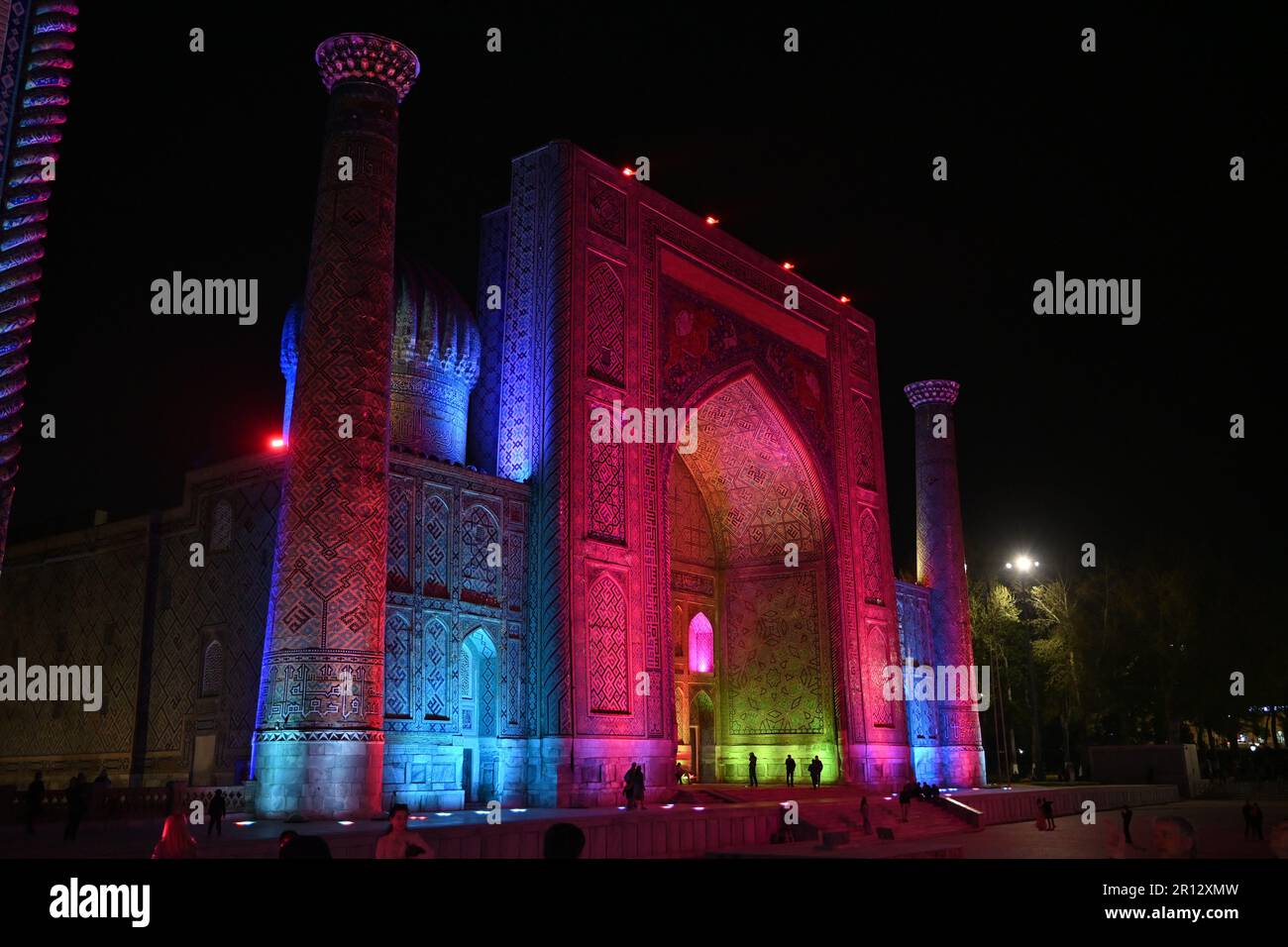 Night view of Registan square and its madrasahs with colorful lights in ...
