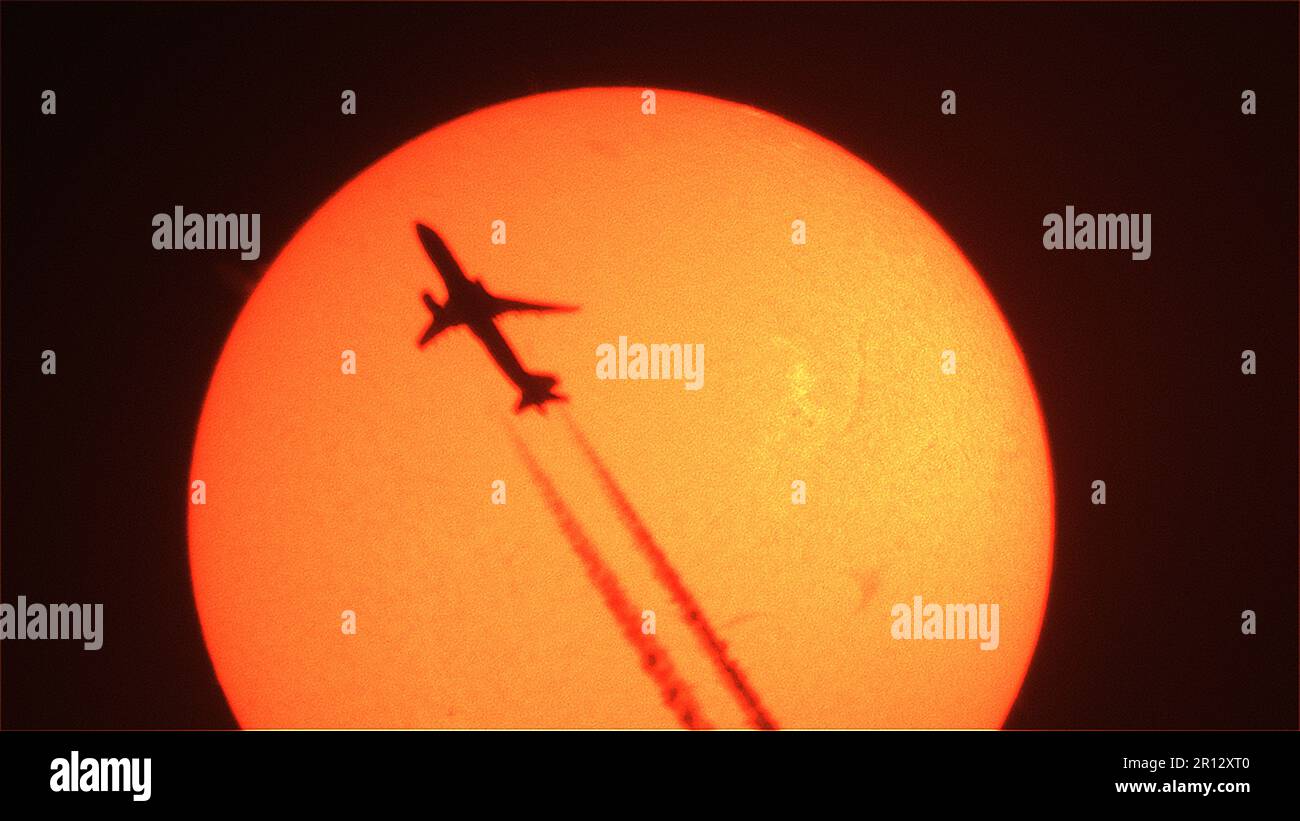 Sun Surface with an Airplane Stock Photo - Alamy