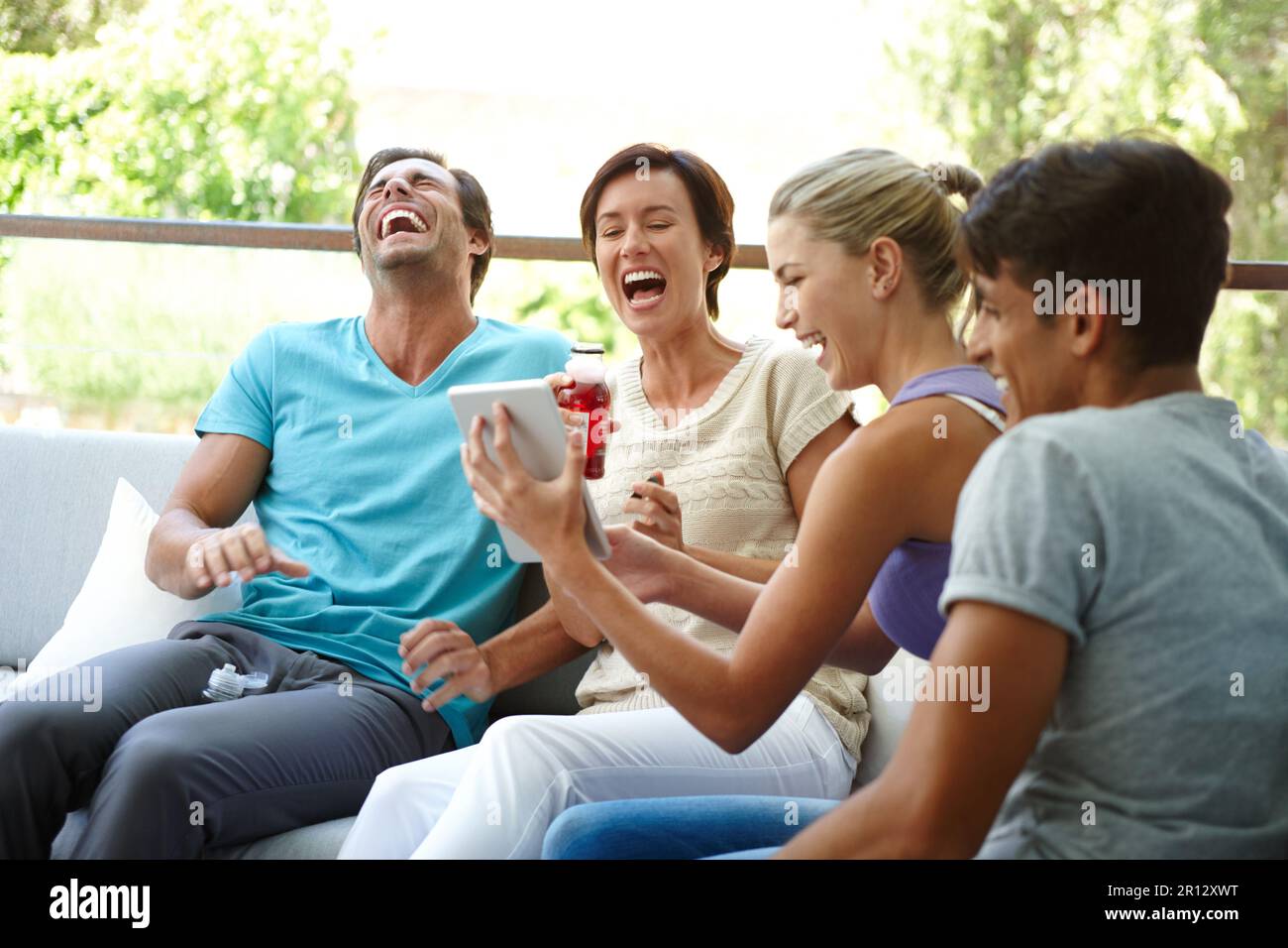 LOL. a group of friends with a tablet laughing at something funny ...