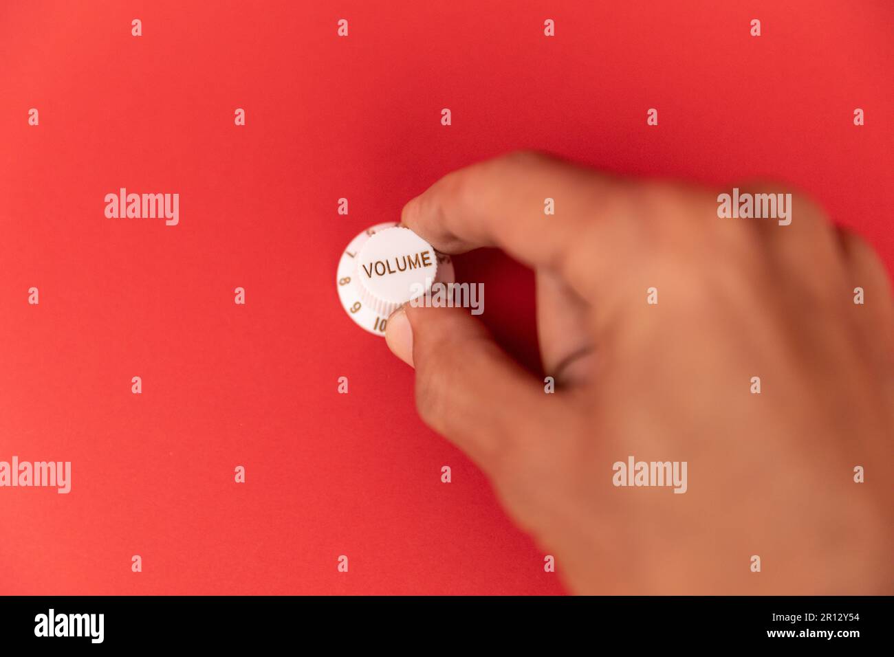 Close up of a black male hand turning volume level Stock Photo - Alamy
