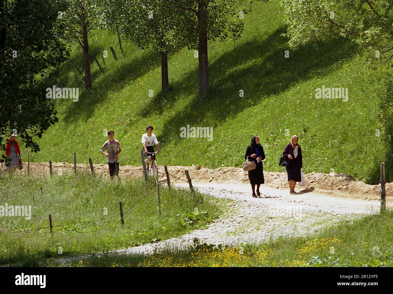 Brasov County, Romania, approx. 1999. Group of local people walking on ...