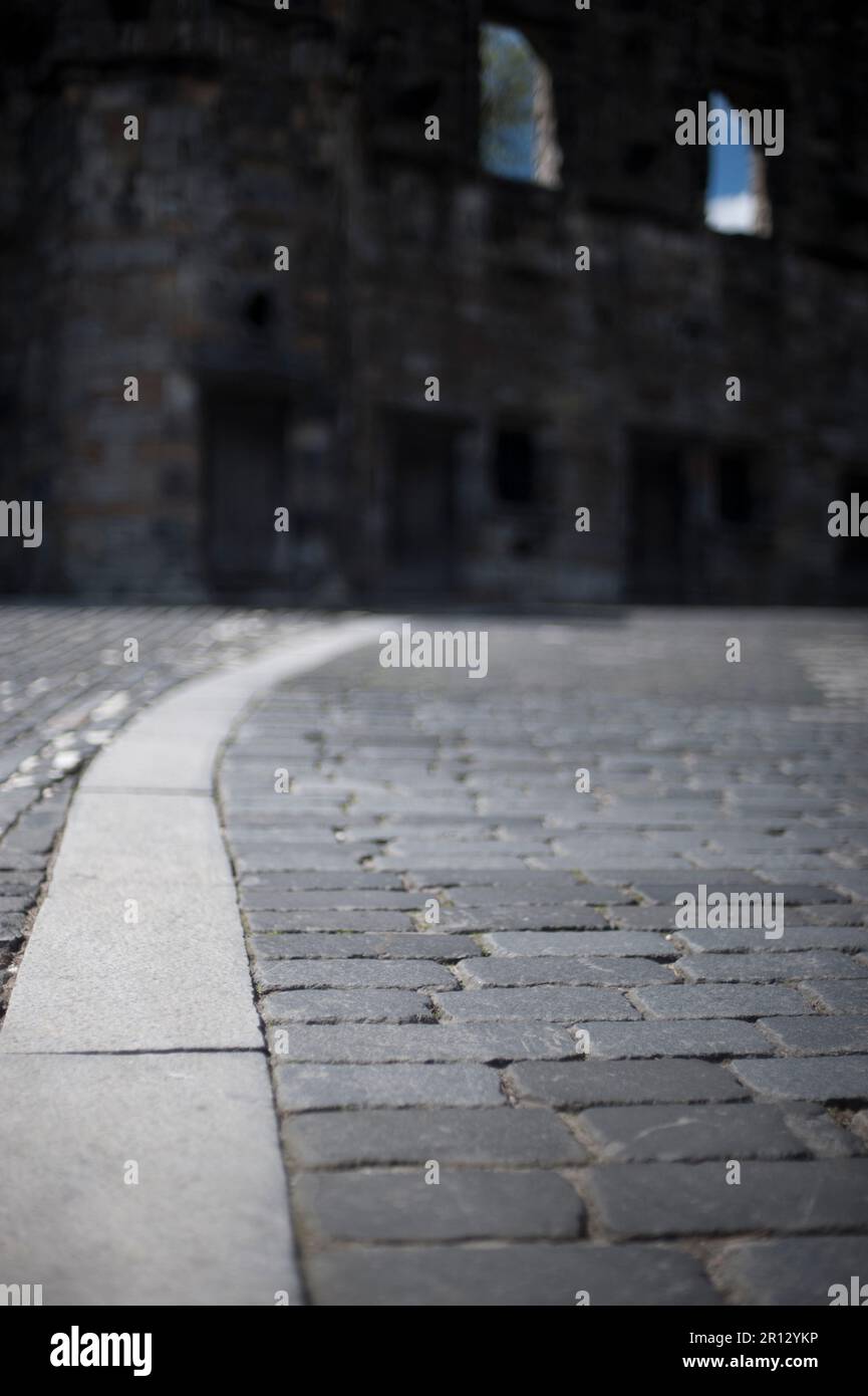Cobbles on a street lead to the walls of a castle in Stirling; Scotland ...
