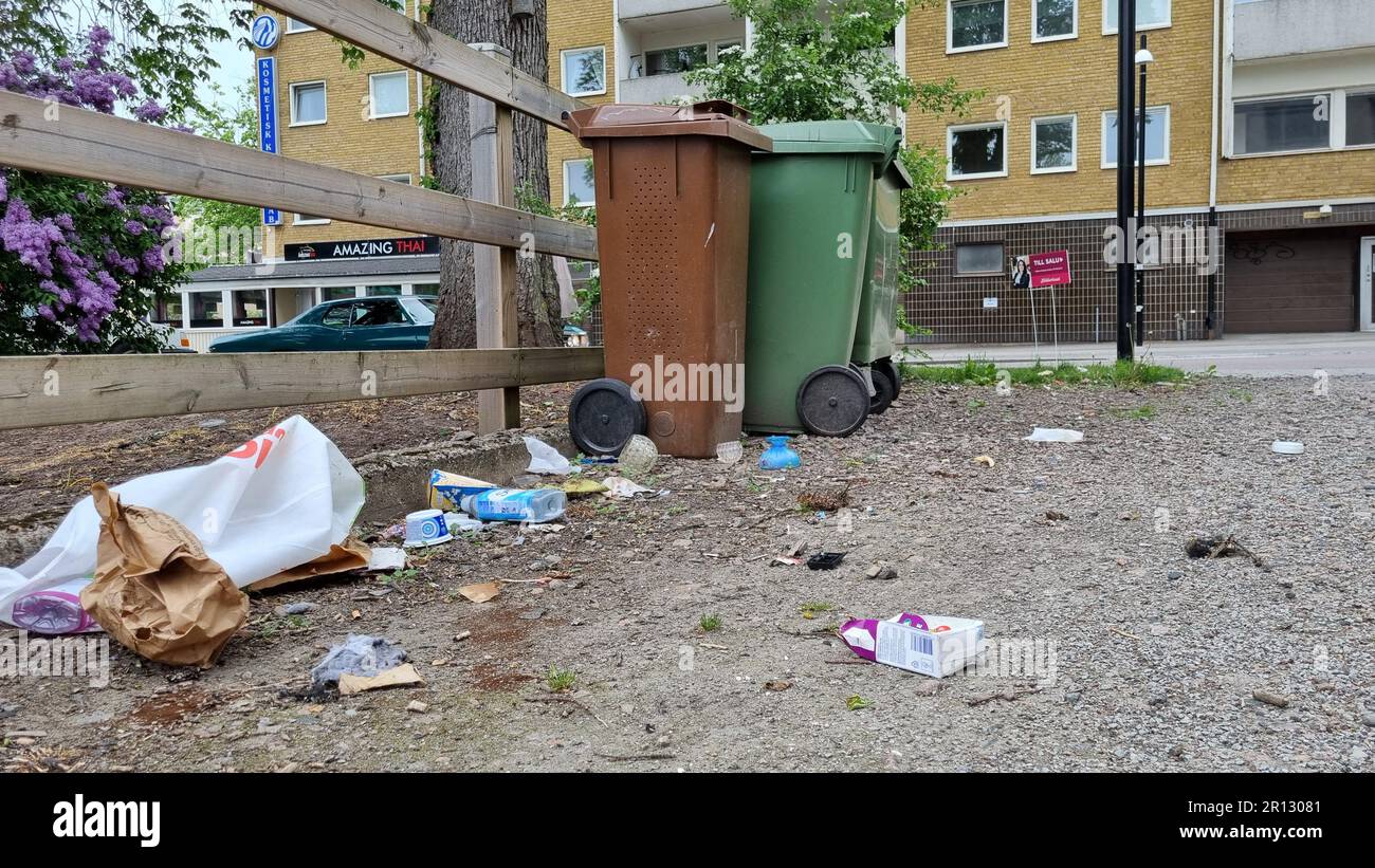 An outdoor scene featuring two wheeled garbage cans Stock Photo - Alamy
