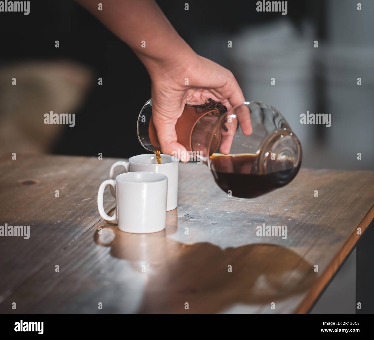 Traditional filtered coffee being poured into cups for tasting Stock ...