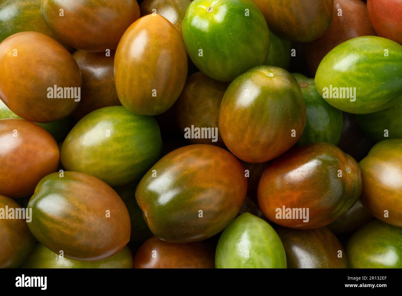 Small cherry tiger tomatoes full frame close up as background Stock ...