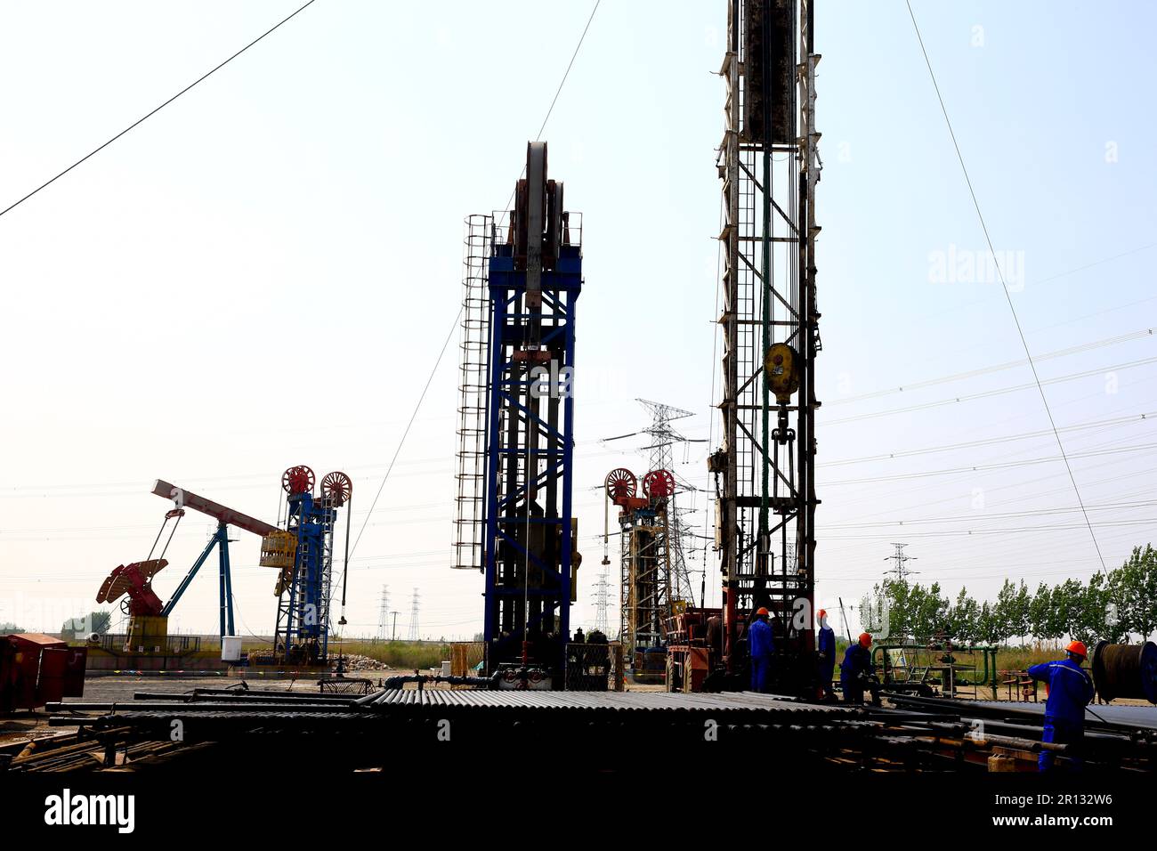 Oil field, the oil workers are working Stock Photo - Alamy