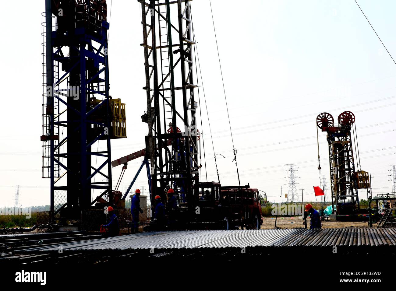 Oil field, the oil workers are working Stock Photo - Alamy