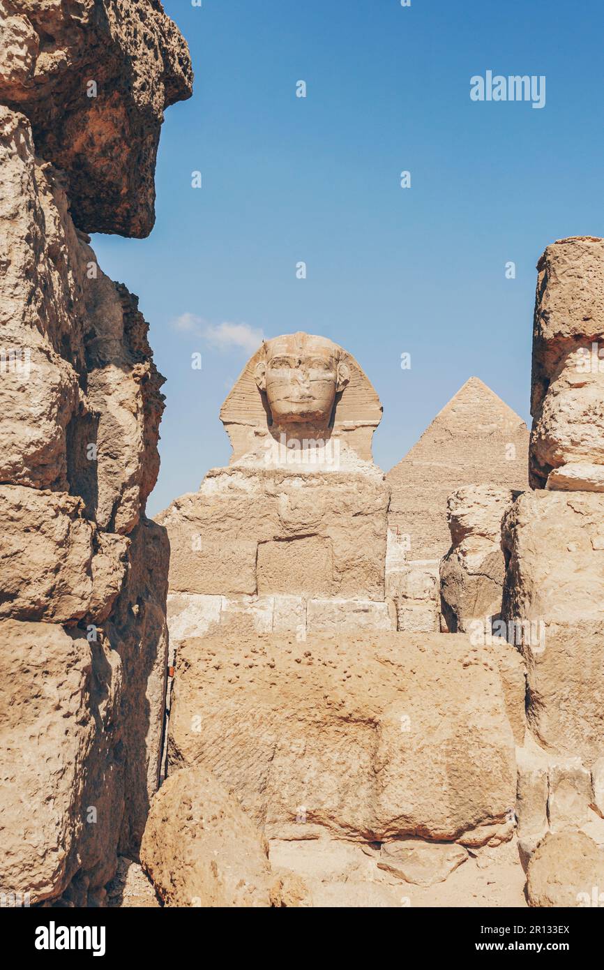 closeup of the face of the Great Sphinx with pyramid in the background ...