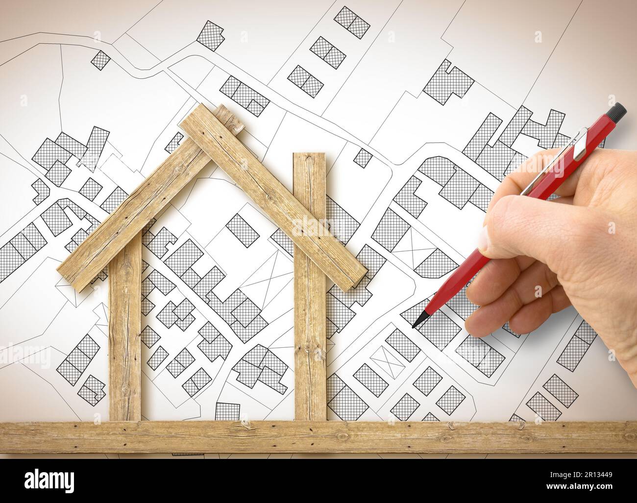 Architect drawing a conceptual wooden house over an imaginary cadastral ...