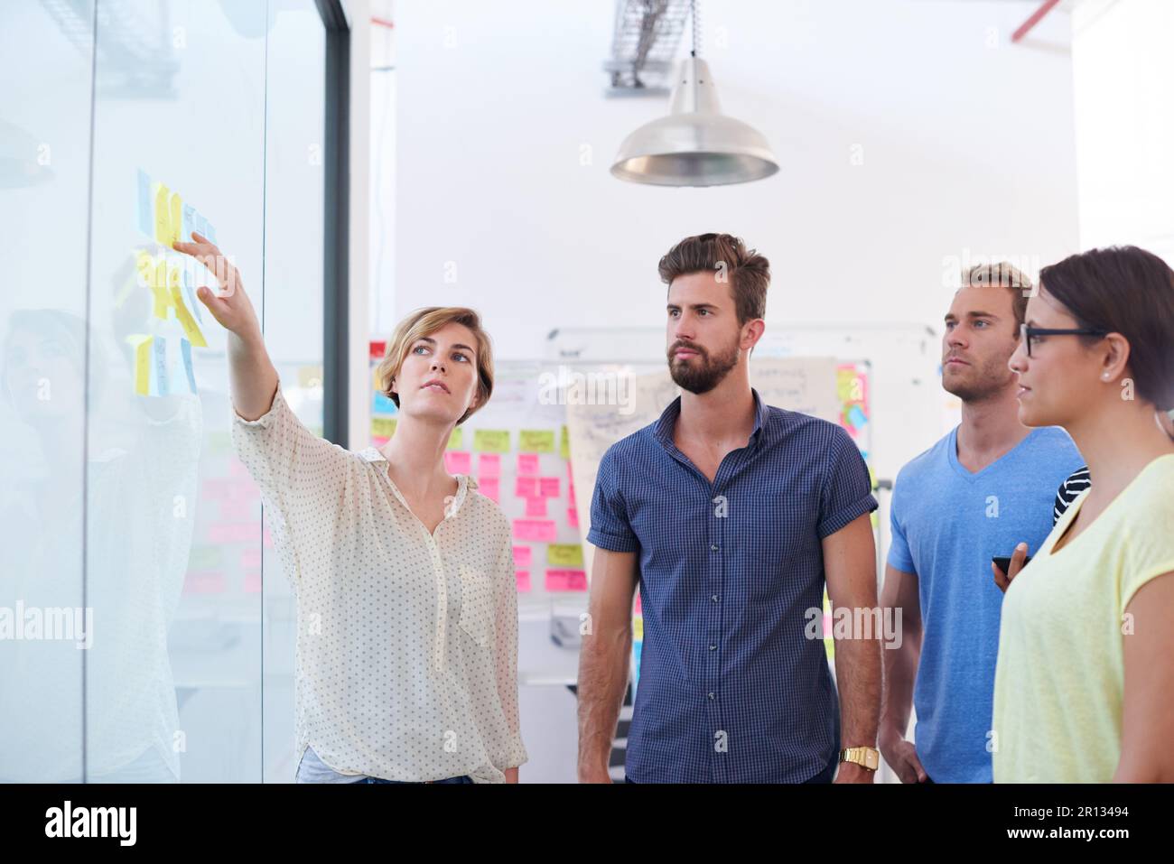 Making ideas happen. a group of colleagues discussing ideas together on ...