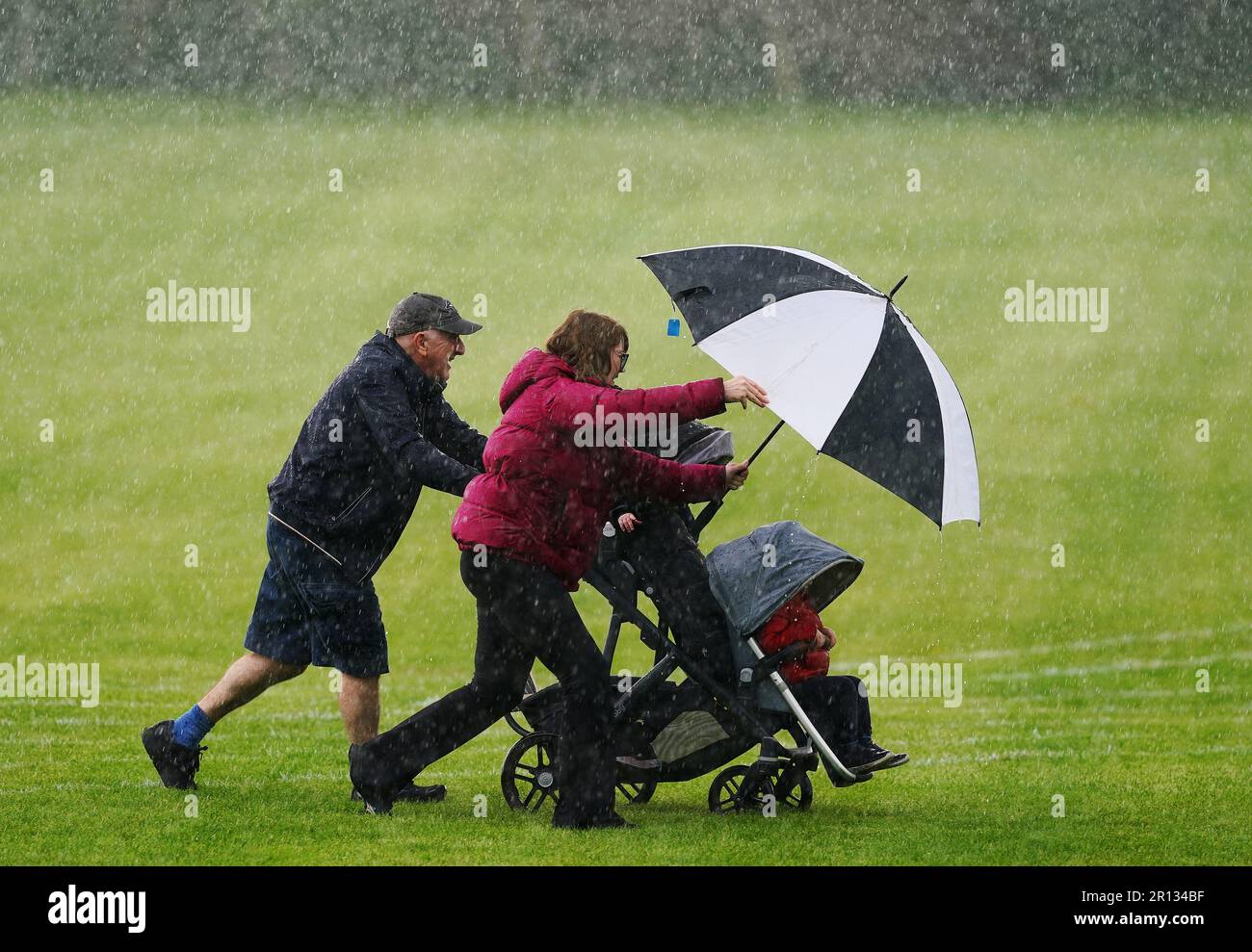 People seek shelter from a heavy rain shower in a park in Terenure ...