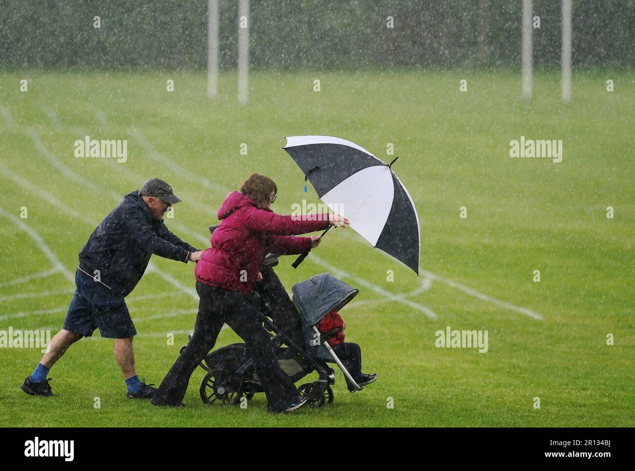 People seek shelter from a heavy rain shower in a park in Terenure ...