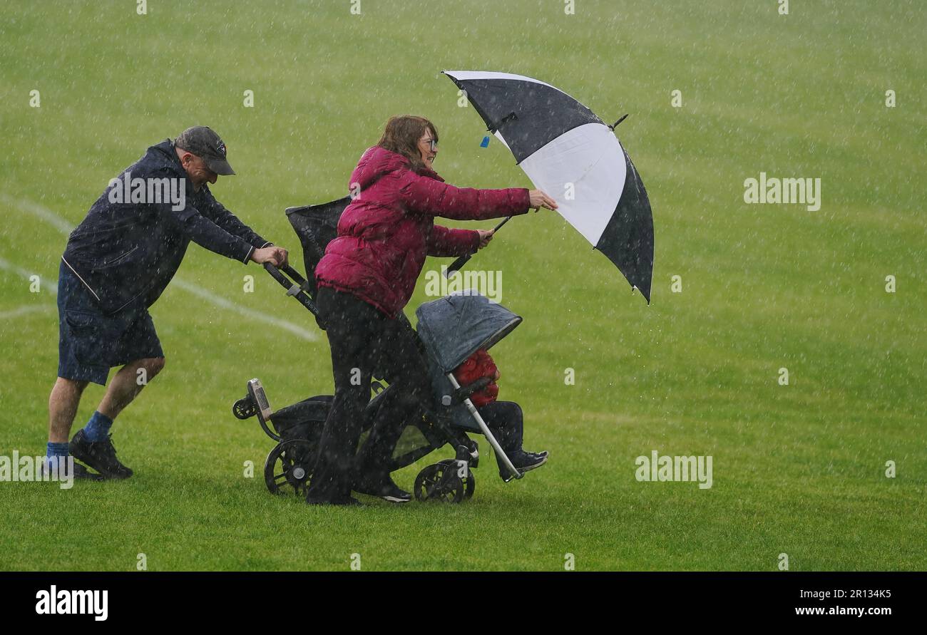 People seek shelter from a heavy rain shower in a park in Terenure ...