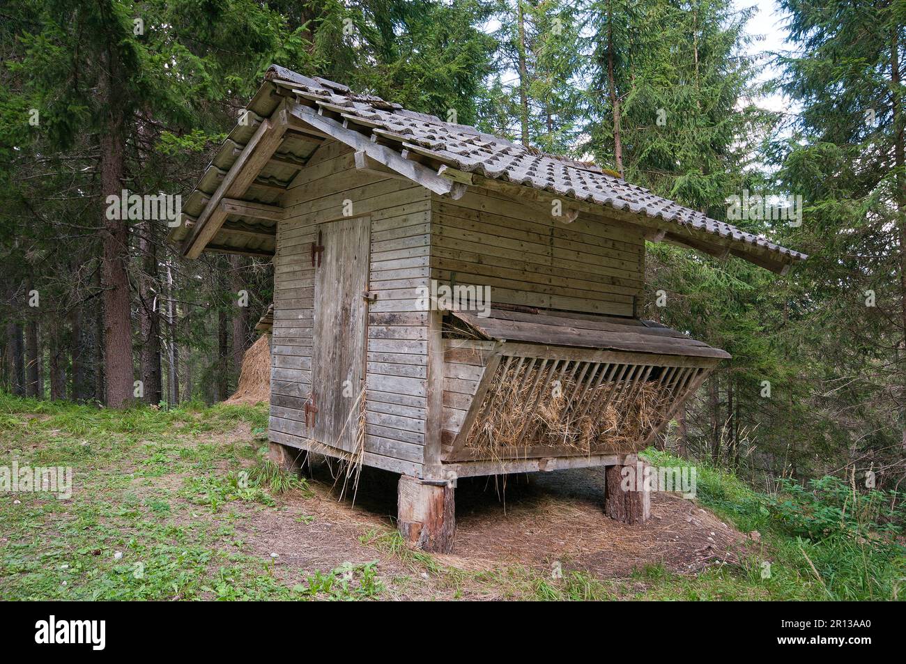 Old traditional alpine barn and animal's feeding trough in Pusteria ...