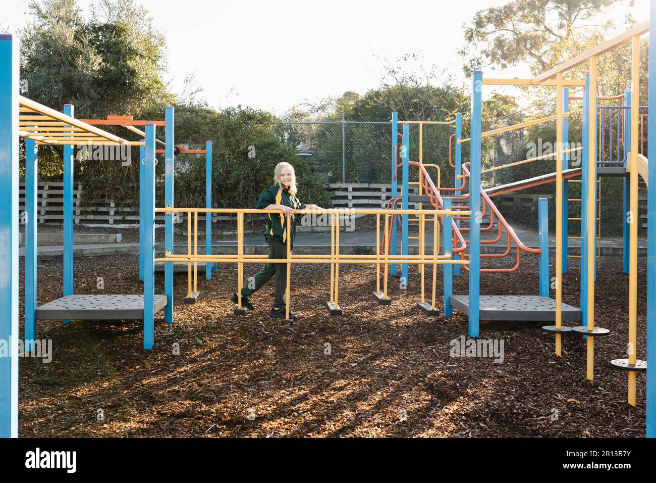 An Australian primary school girl playing on a playground in the school ...