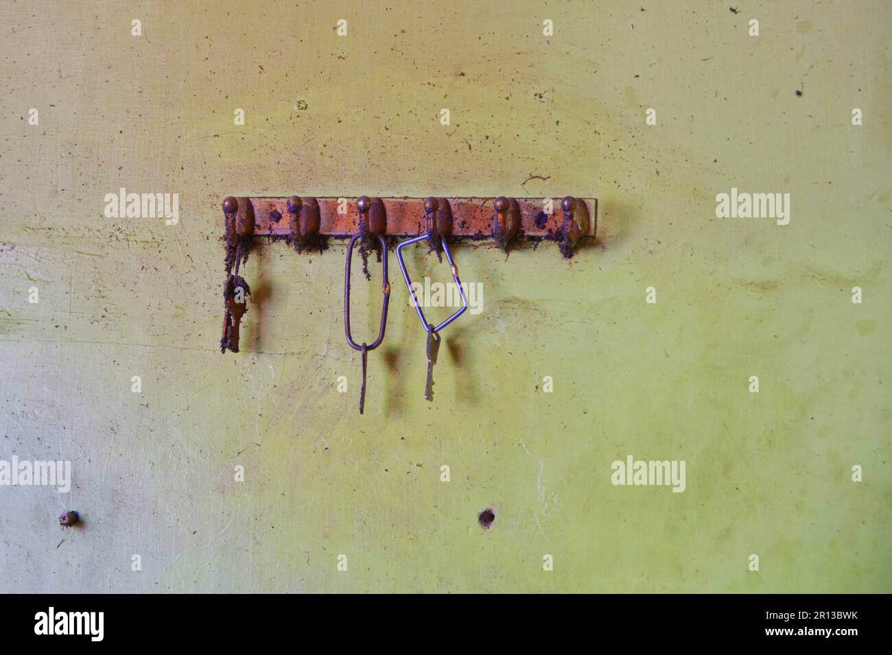 Dusty hook with keys on the dirty green wall of an old building Stock ...