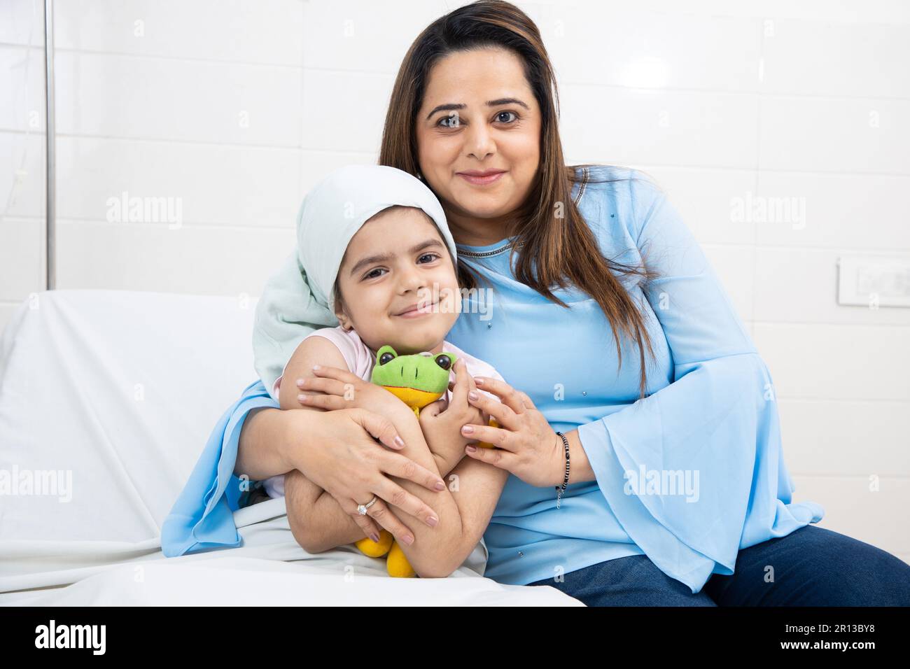 Indian woman hug her little daughter cancer patient undergoing course ...
