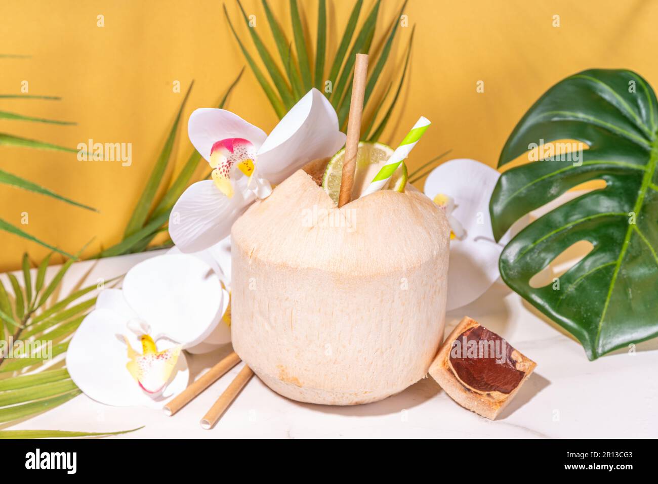 Young Thai coconut cocktail or juice, tropical summer drink in whole ...